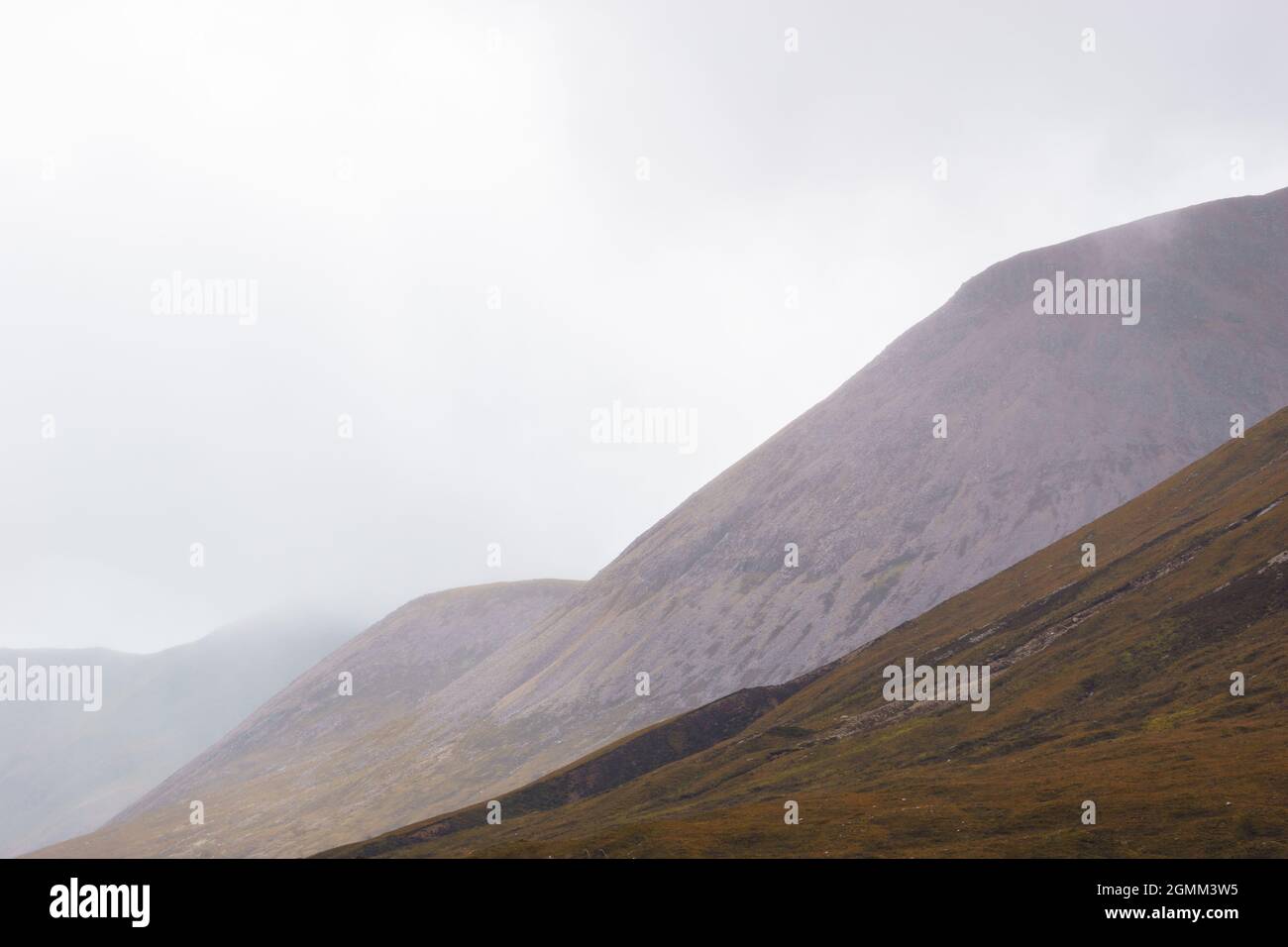 Detail of mountain range of scottish landscape covered in fog on Isle ...