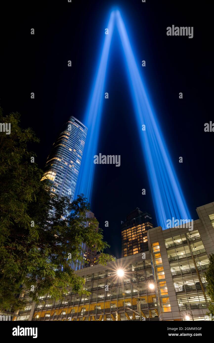 9/11 Tribute in Light. Lower Manhattan illuminated at night. Battery ...