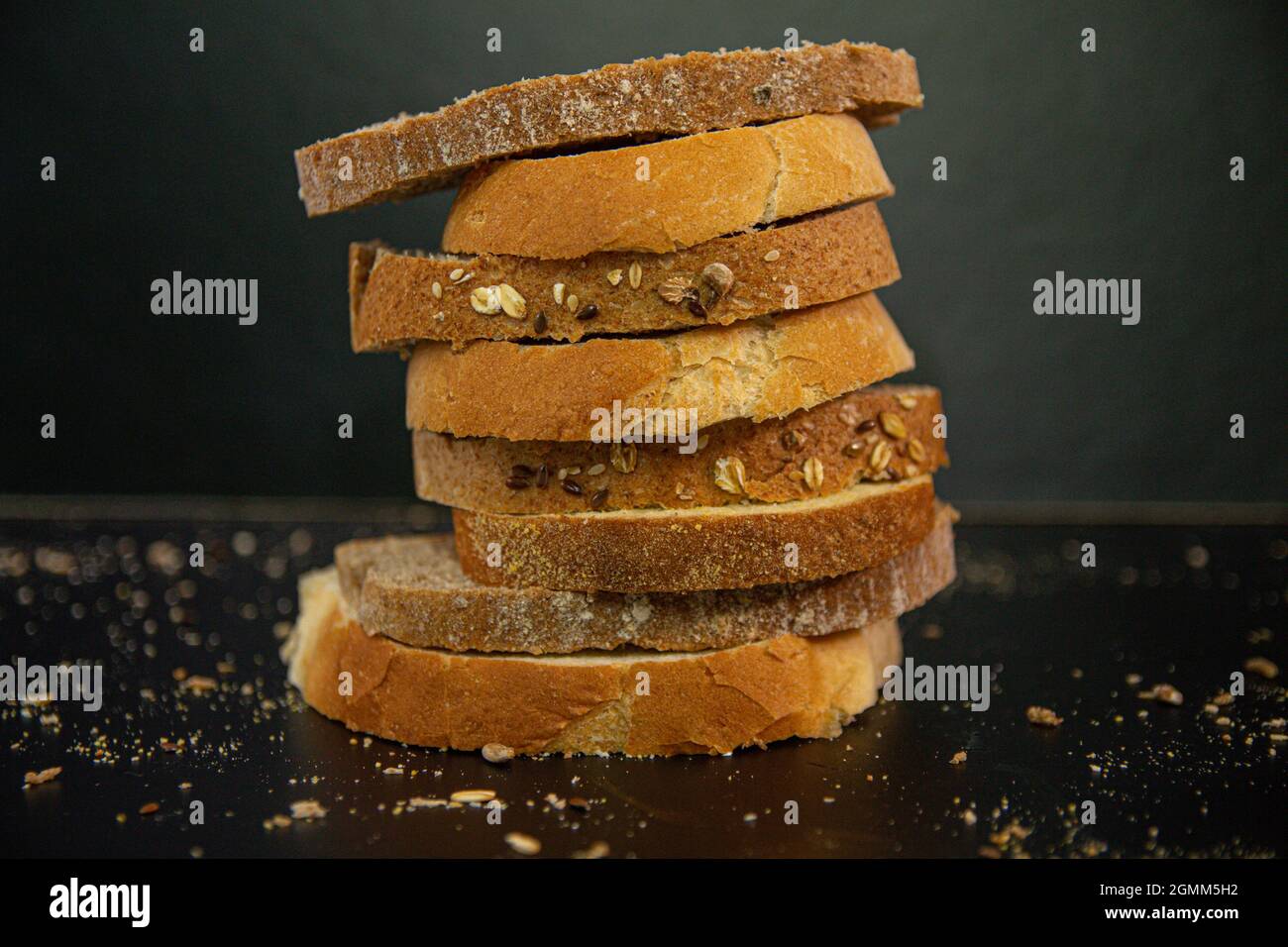 Stack of sliced loaves of bread on a table Stock Photo - Alamy