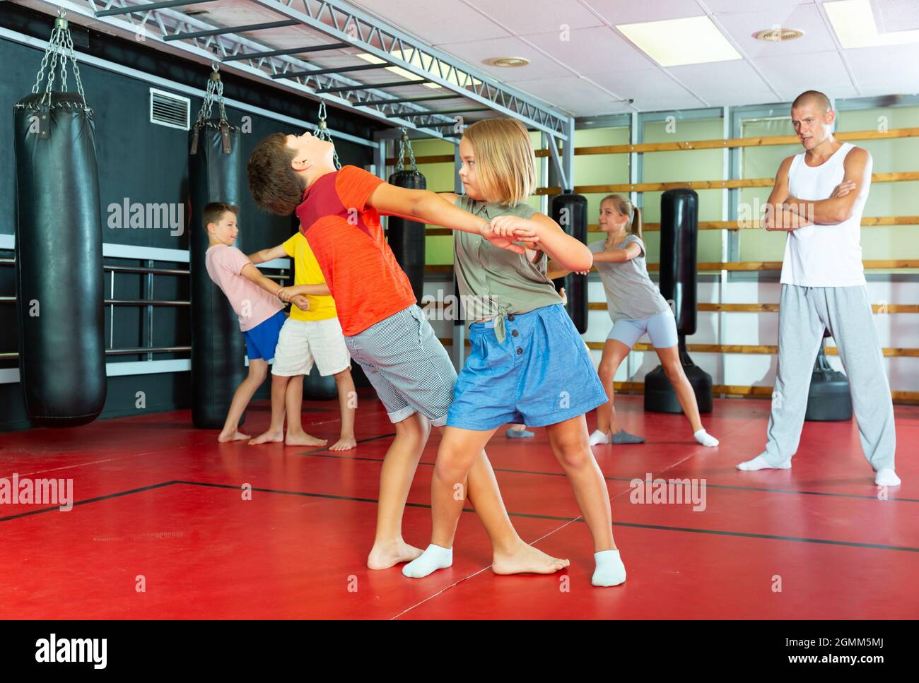 Kids in pair exercising self-defense movements Stock Photo - Alamy