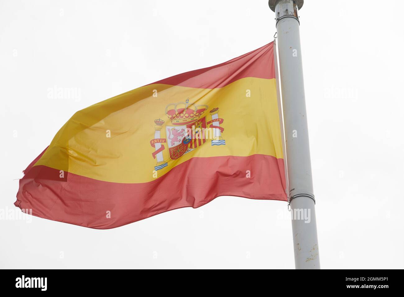 Spanish flag on a pole, undulating in the wind Stock Photo - Alamy