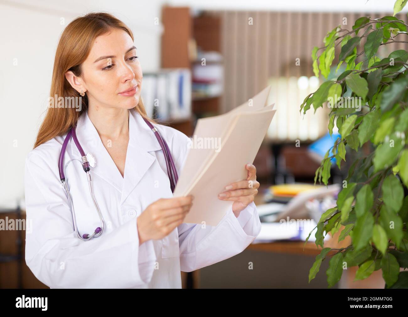 Female doctor reviewing medical history of patient in office Stock ...
