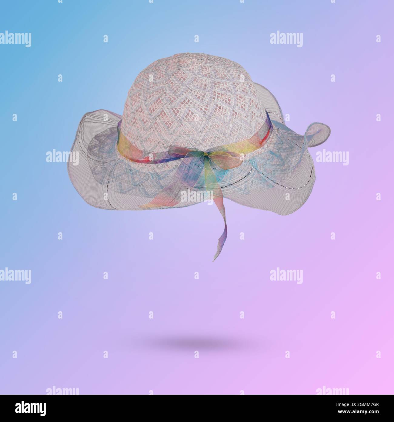 Summer Hat floating in the air on a background illuminated by a blue ...