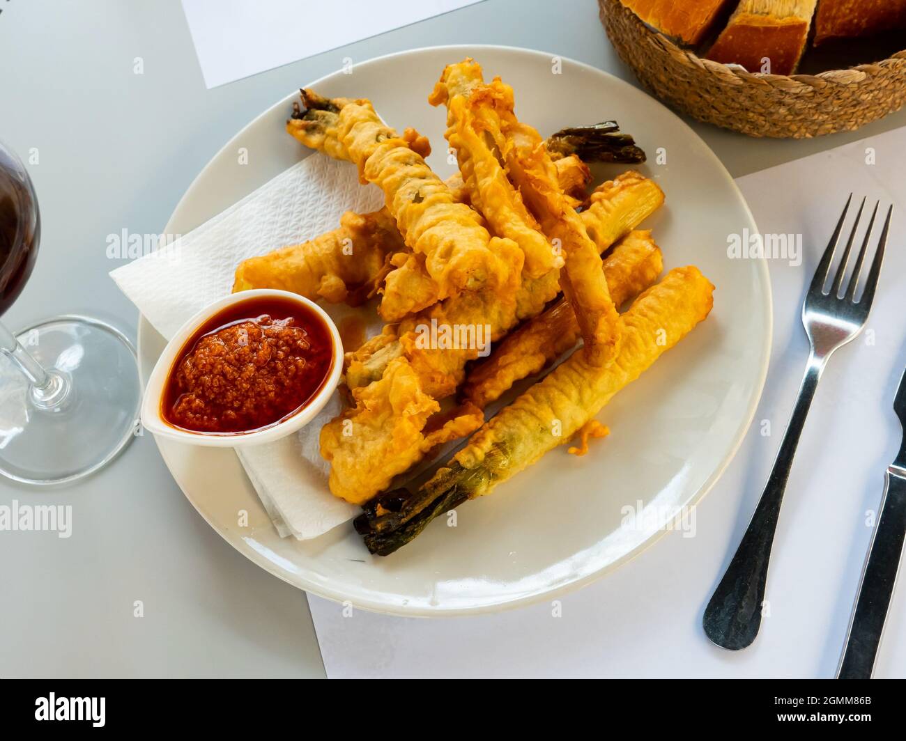 Tempura fried calcots served with Romesco sauce Stock Photo - Alamy