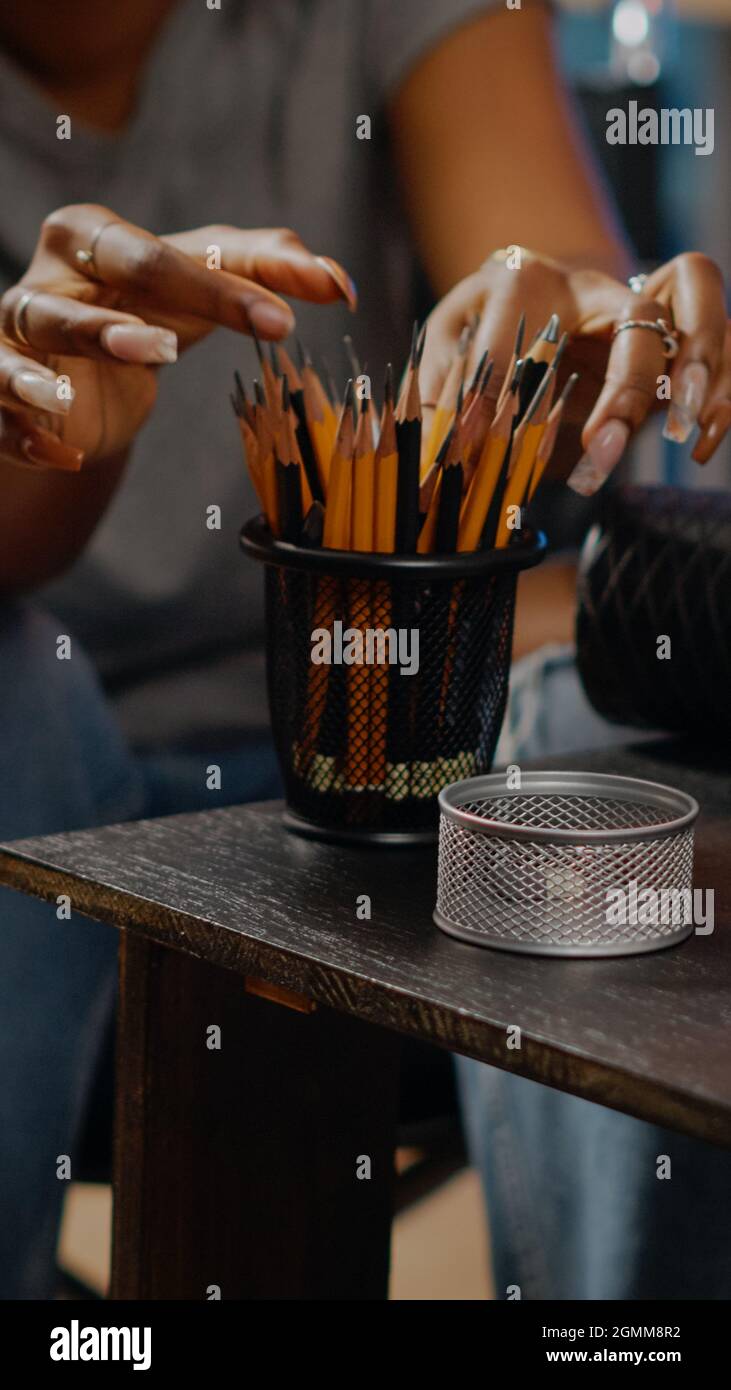 Close up of art tools and pencils on table in artwork space at home ...