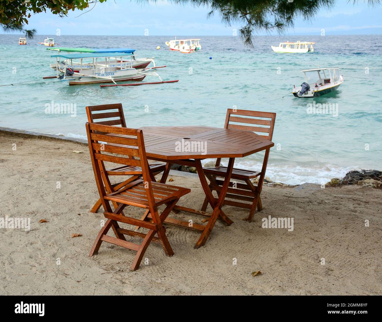 Wooden table and chairs with seascape background, summer concept for ...