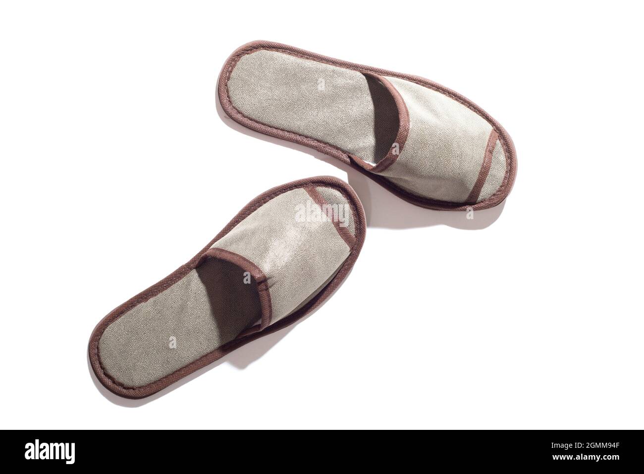 Gray one-off slippers for hotel on a white background Stock Photo - Alamy