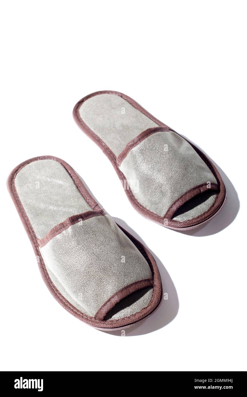 Gray one-off slippers for hotel on a white background Stock Photo - Alamy