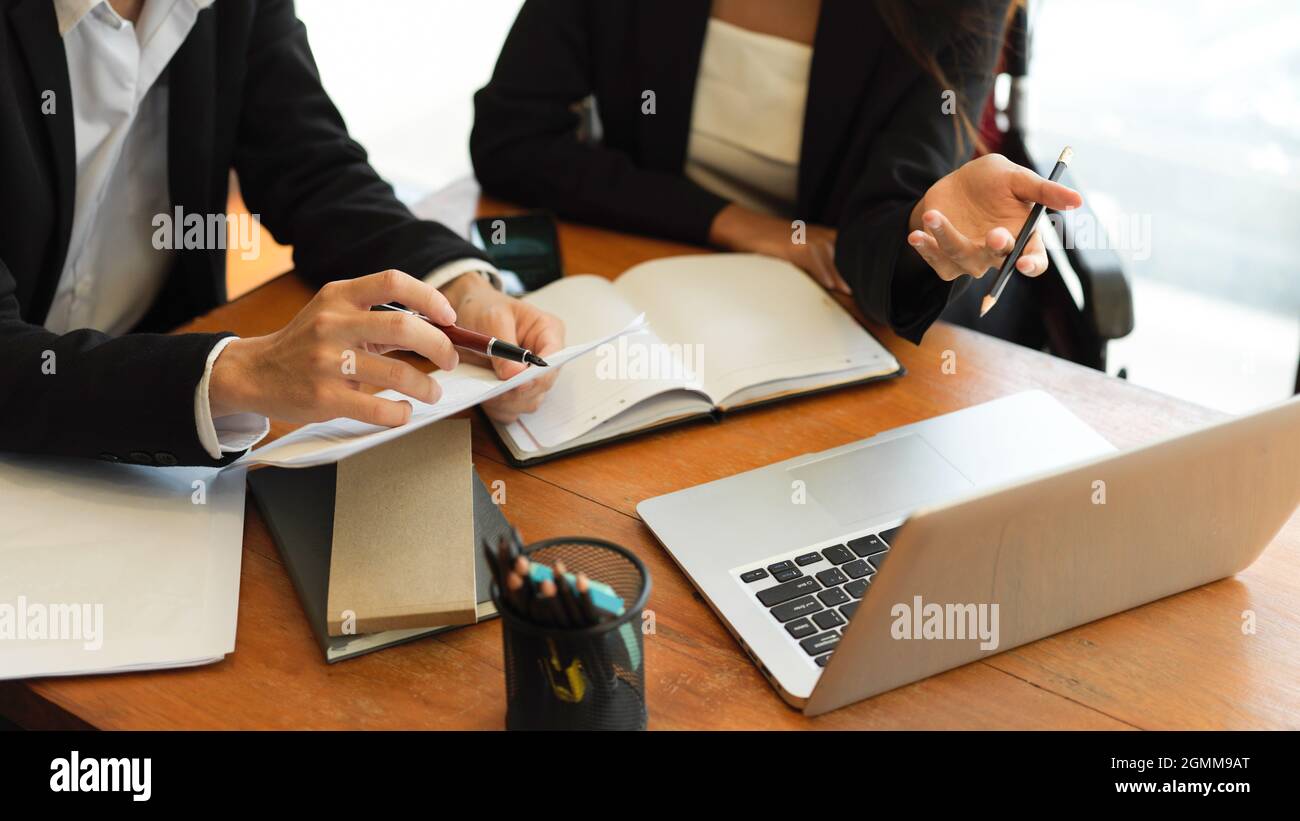 Closeup of Business team working together, discussing business project ...