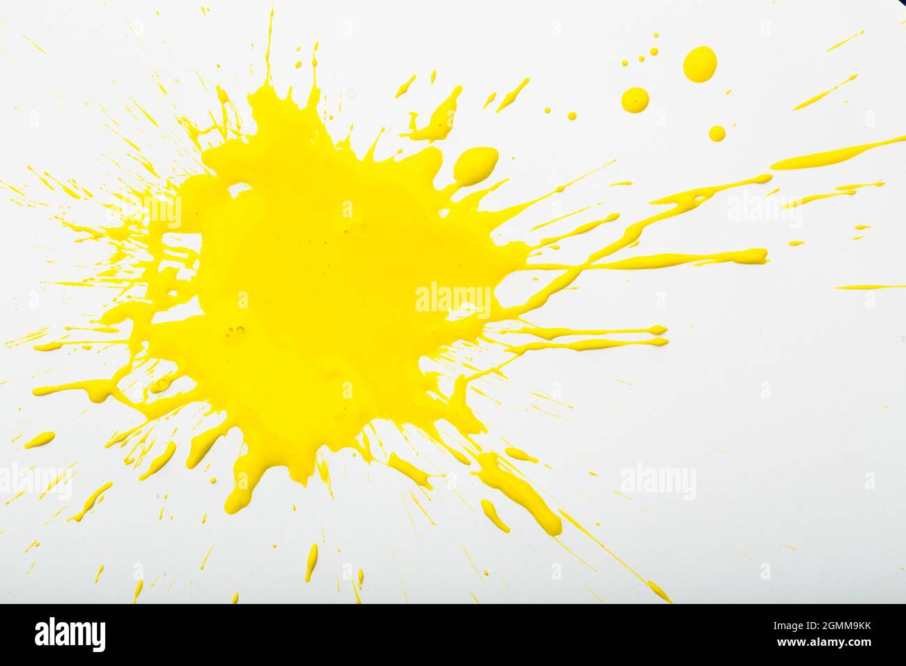 Yellow paint spots on paper, colorfull artistic image on white ...