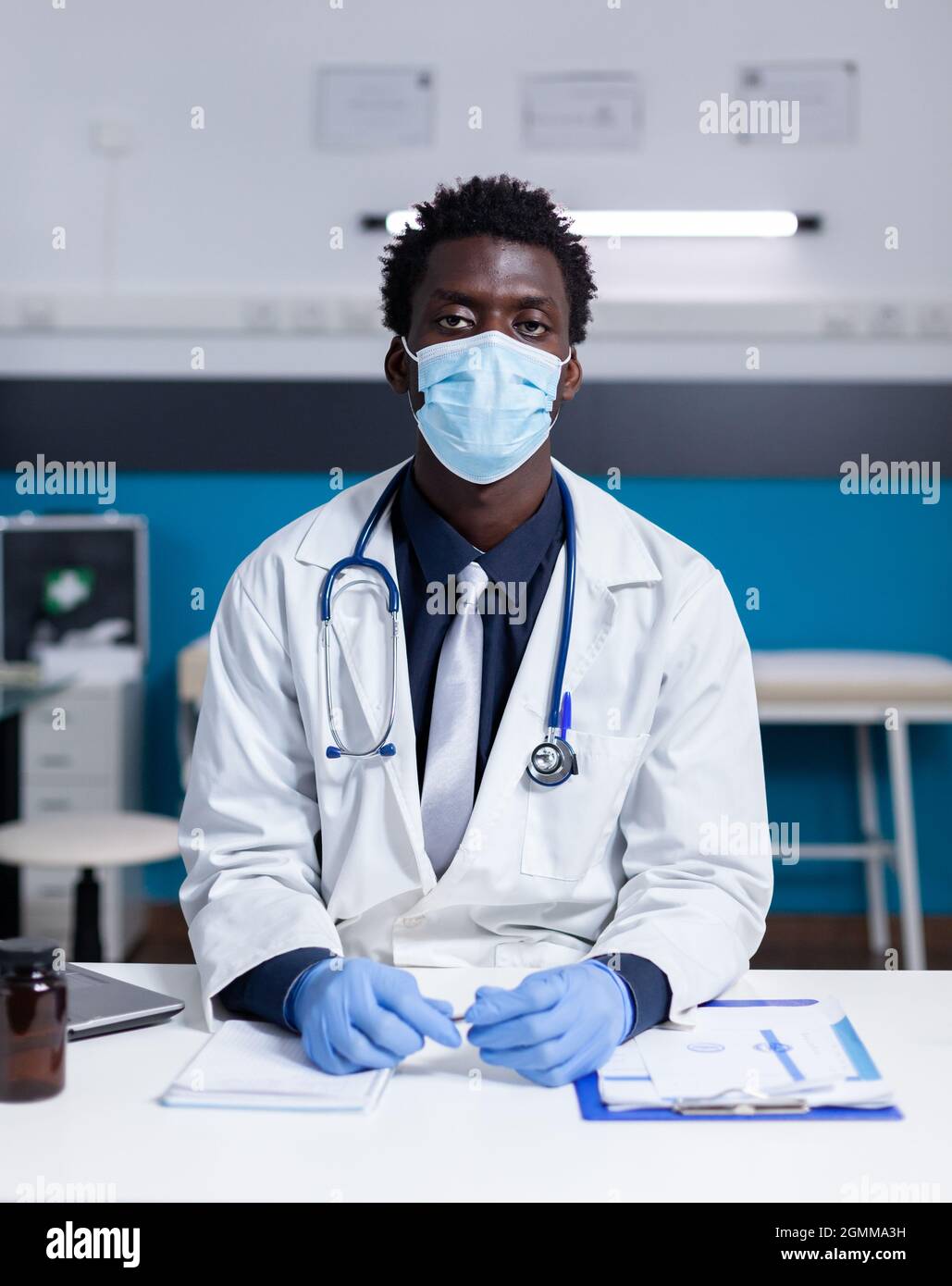 Portrait of african american medic looking at camera wearing gloves and ...