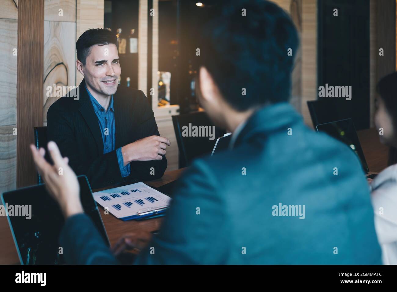 During a job interview, a man in a suit and gives a presentation about ...