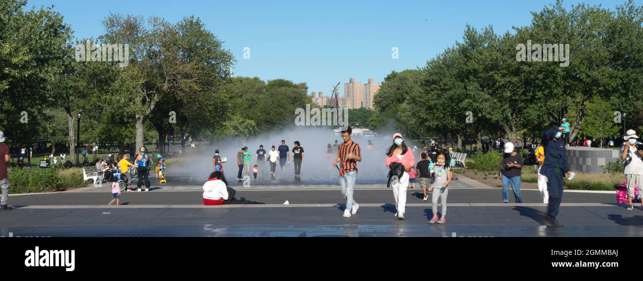 Visitors to Flushing Meadows Corona Park stroll and bath in the ...