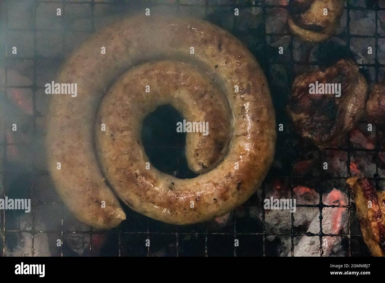South African style sausage coil grilling on a barbecue, top view Stock ...