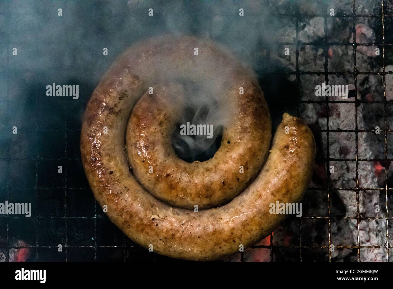 South African style sausage coil grilling on a barbecue, top view Stock ...