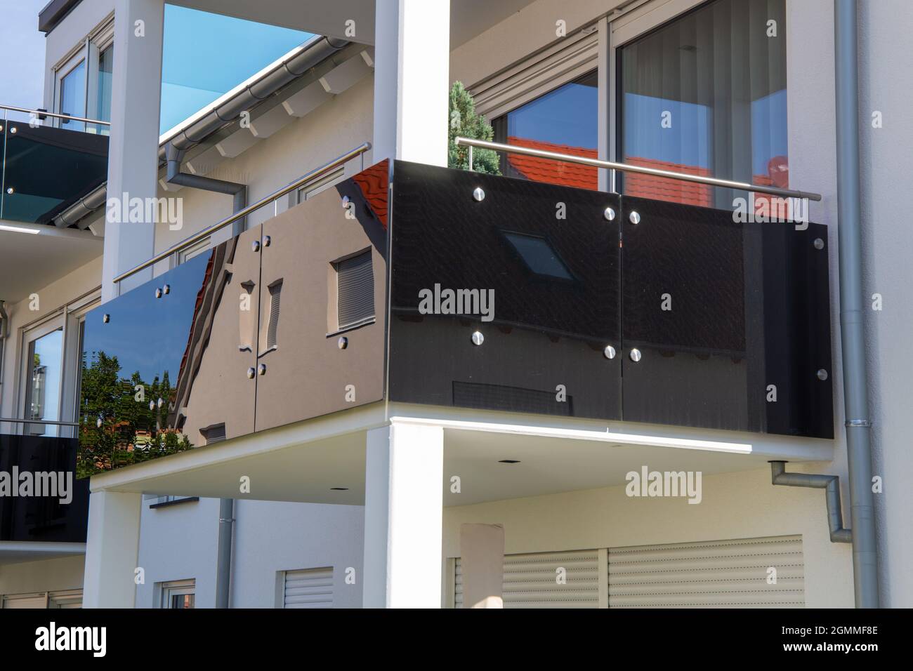 Black balcony railing made of glass and stainless steel Stock Photo - Alamy