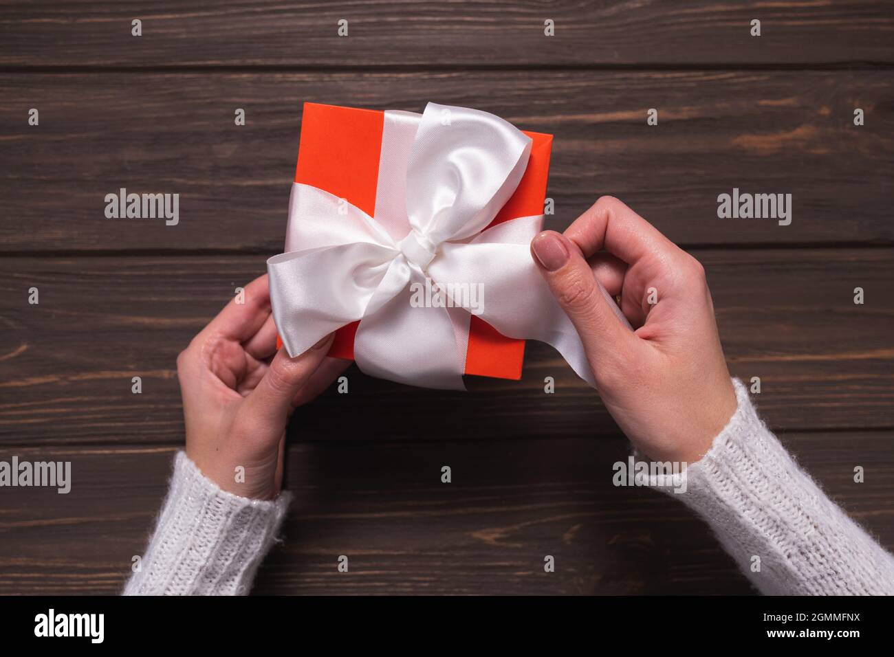 Womens hands untie bow hi-res stock photography and images - Alamy