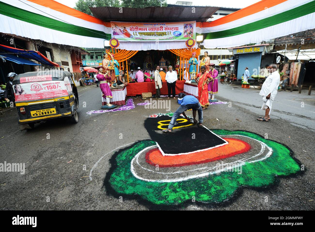 A man preparing a colorful rangoli in Pune, India Stock Photo - Alamy