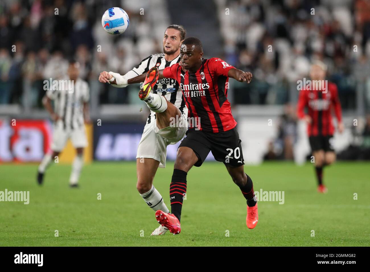 Turin, Italy, 19th September 2021. Adrien Rabiot of Juventus battles for possession with Pierre ...