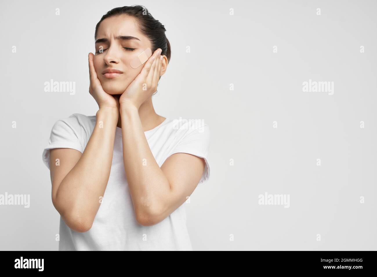 woman holding his head trauma health problems light background Stock ...