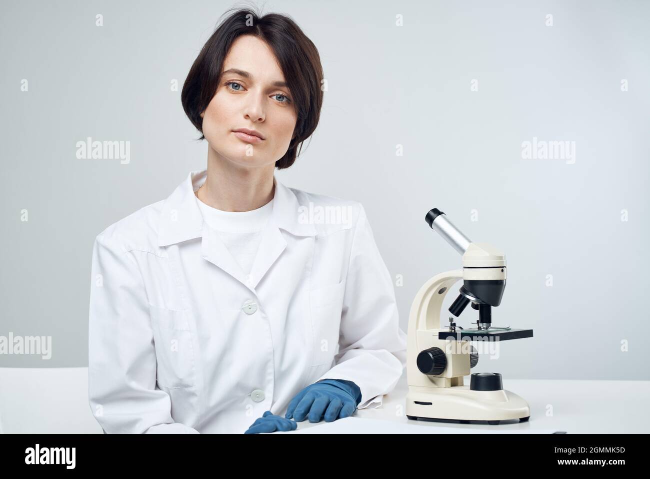 female scientist in white coat laboratory microscope science experiment ...