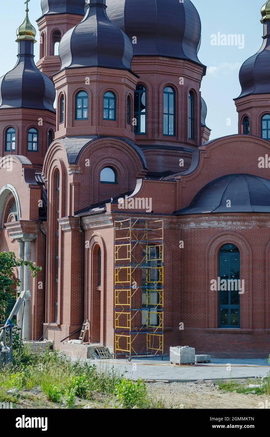 Construction scaffolding opposite Red brick building with arches Stock ...