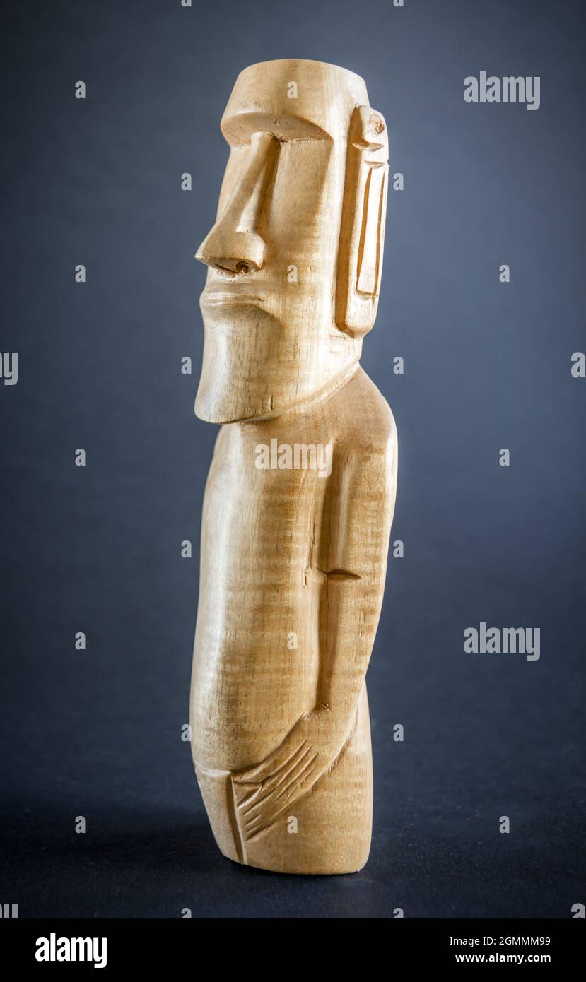 Traditional wooden statue of a moai from Easter Island. Dark background ...