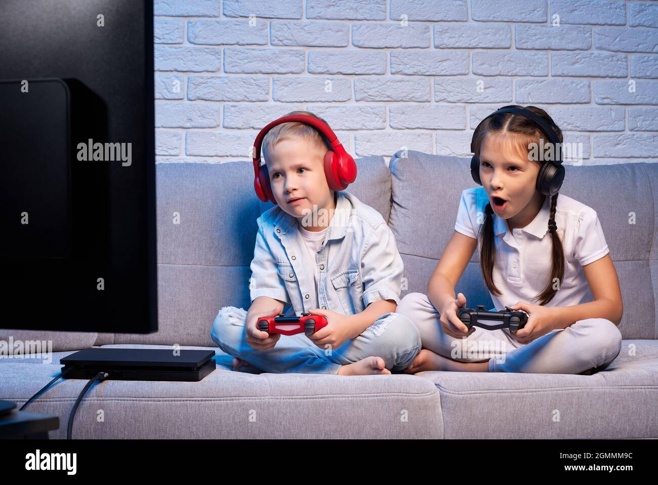 children playing video game with game console Stock Photo - Alamy