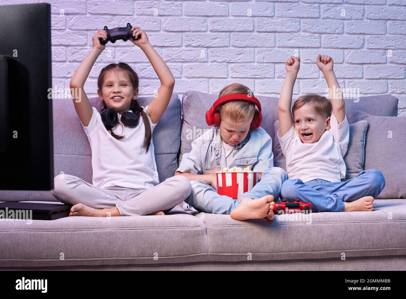 children playing video game with game console Stock Photo - Alamy