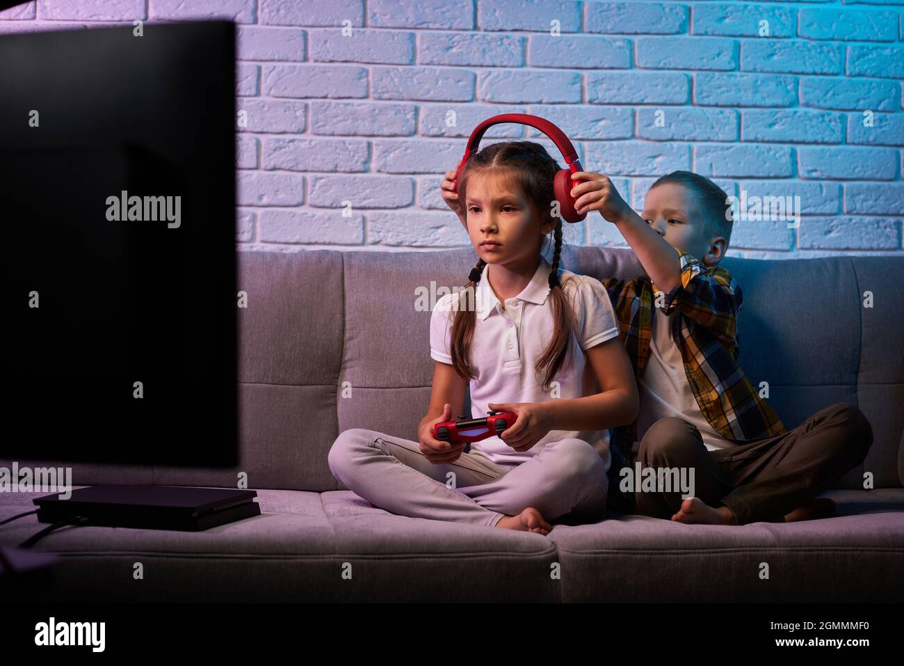 children playing video game with game console Stock Photo - Alamy