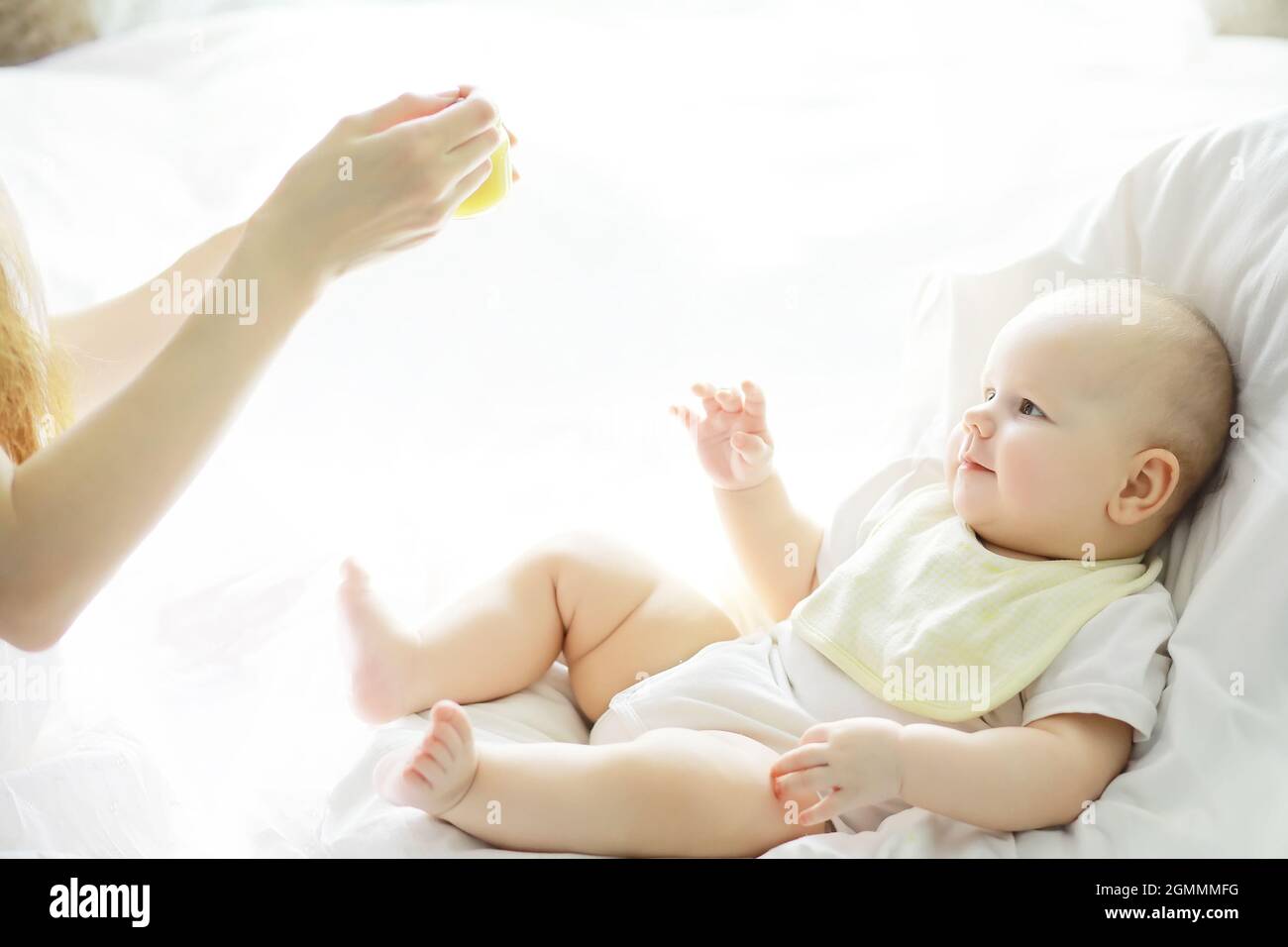Maternity concept. A young mother feeds her little baby. First lure and ...