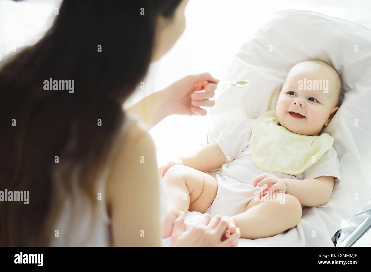 Maternity concept. A young mother feeds her little baby. First lure and ...