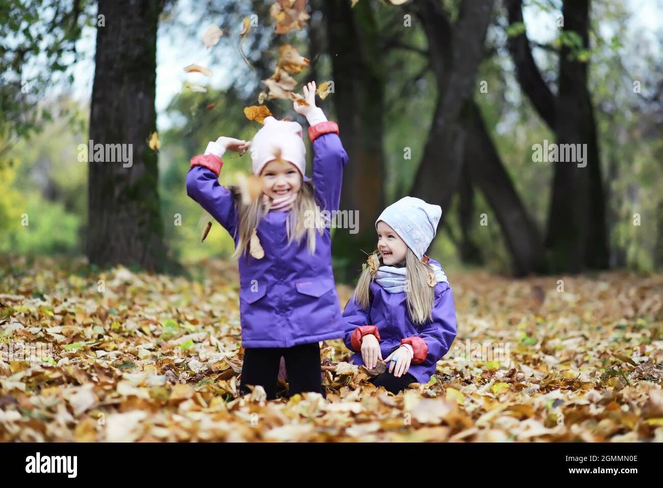 Children for a walk in autumn park. Leaf fall in the park. Family. Fall ...