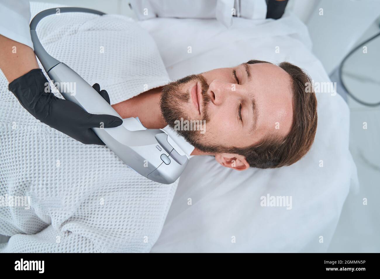 Cute bearded patient undergoing the ultrasonic skin tightening Stock ...