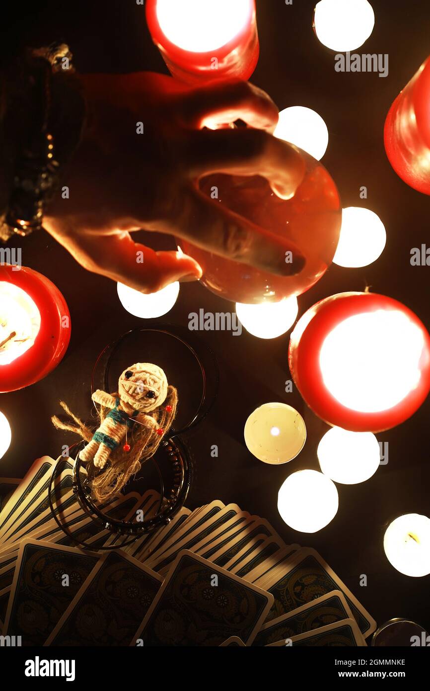 Mystic still life with voodoo doll, the tarot cards, books, evil ...