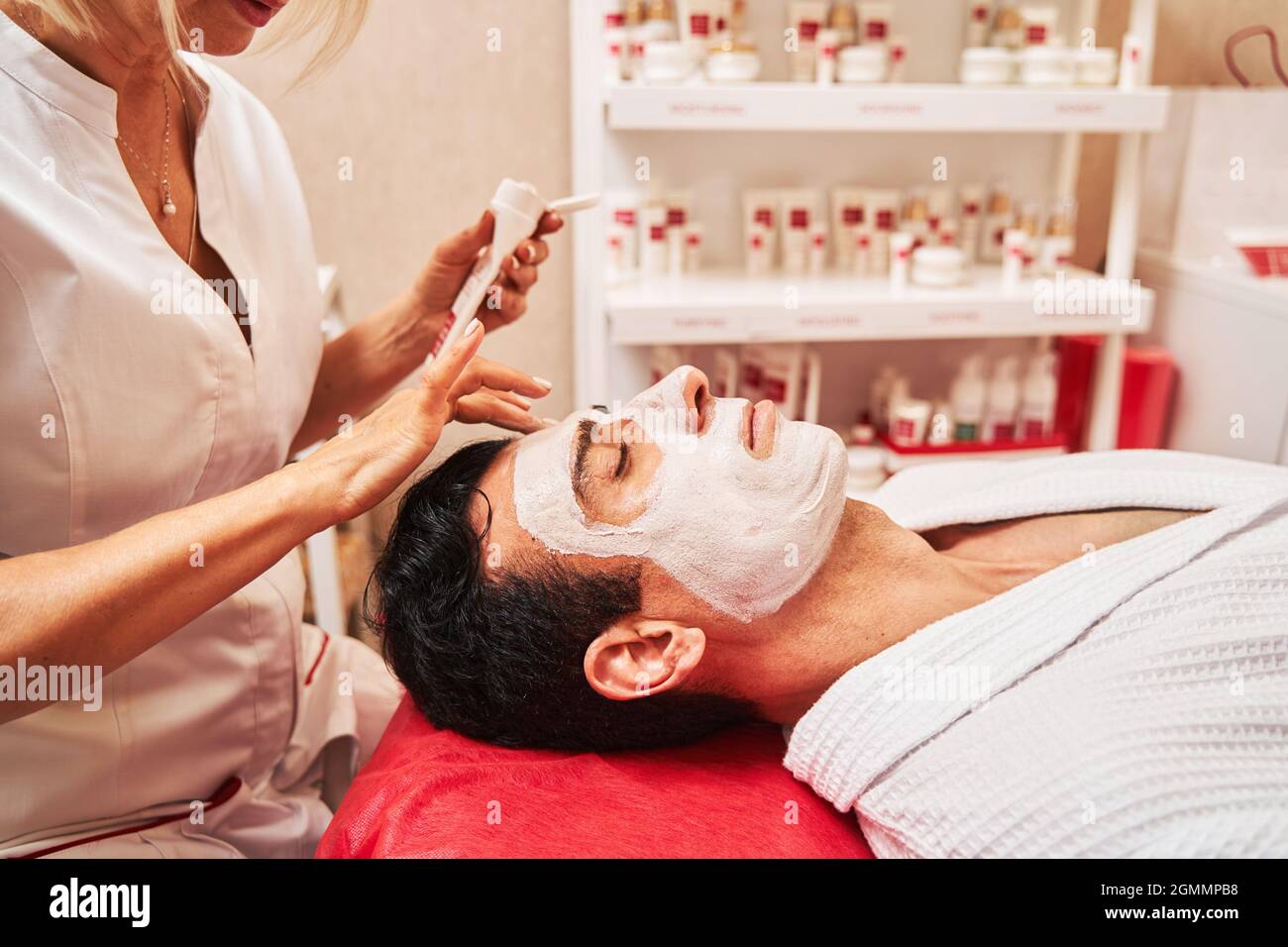 Cosmetologist smear moisturizing cream on hi-res stock photography and ...