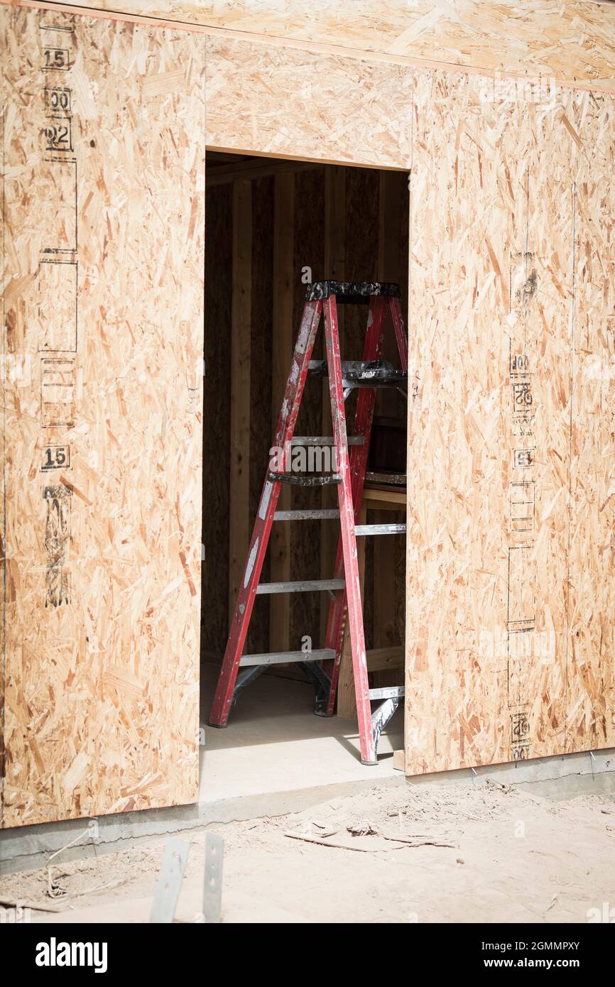 Ladder inside construction site doorway Stock Photo - Alamy