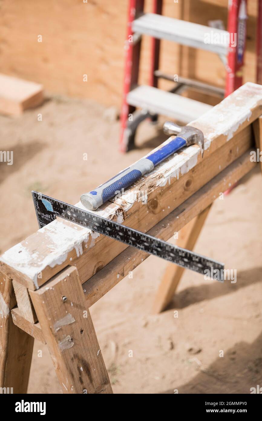 Hammer and carpenter square ruler at construction site Stock Photo - Alamy