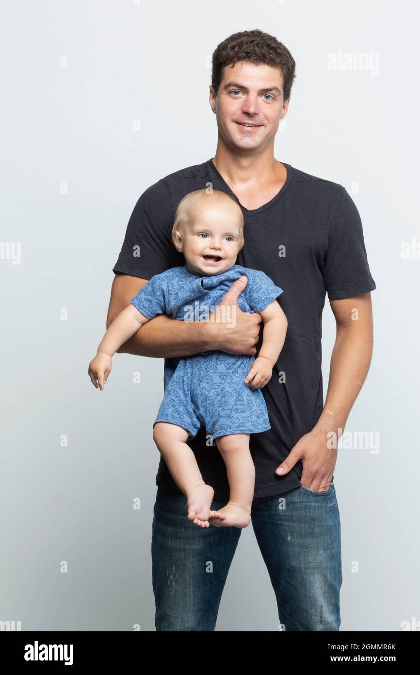 Portrait happy father holding baby son on white background Stock Photo ...