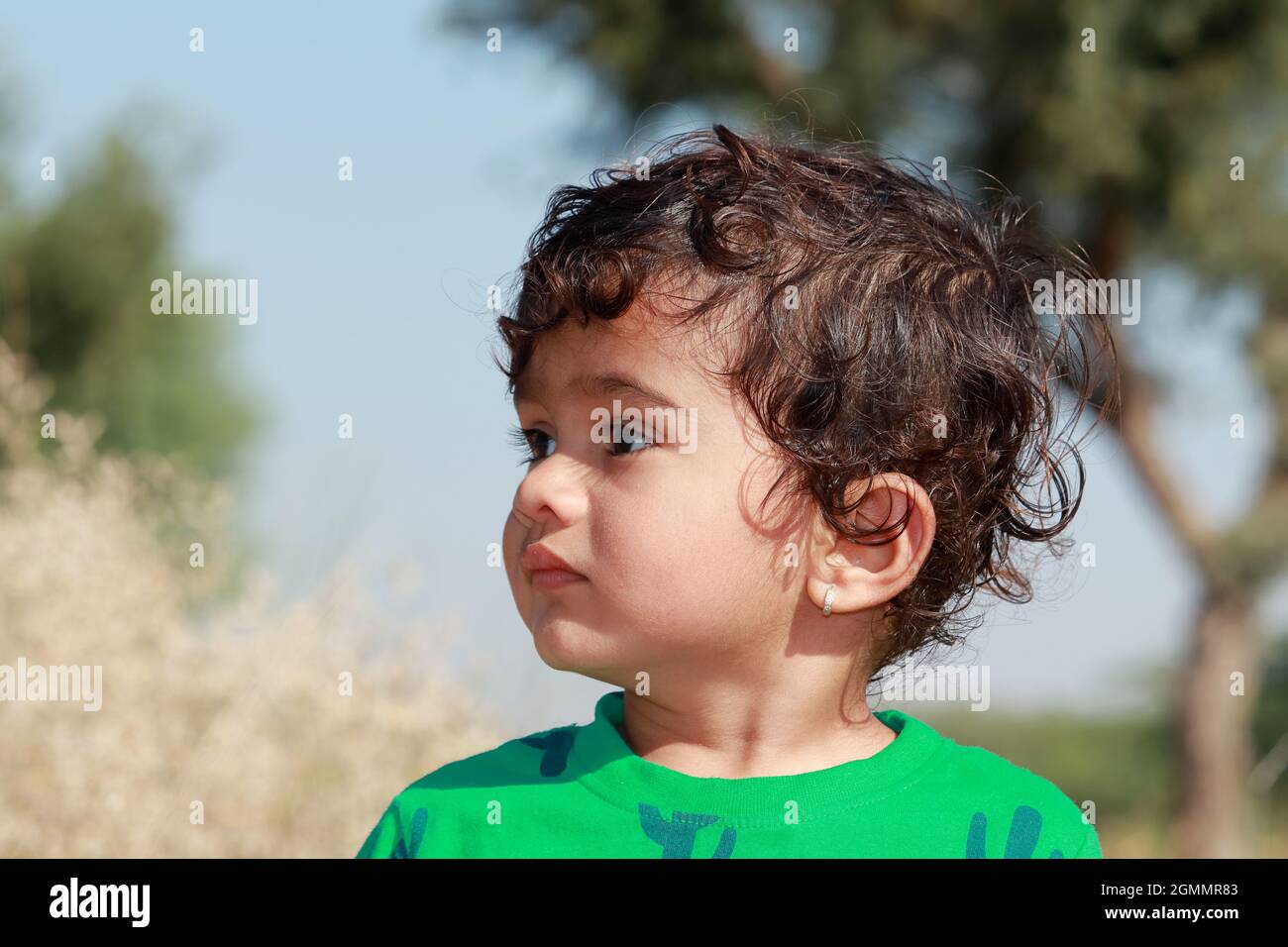 close-up profile view portrait of A small cute Indian Hindu child ...