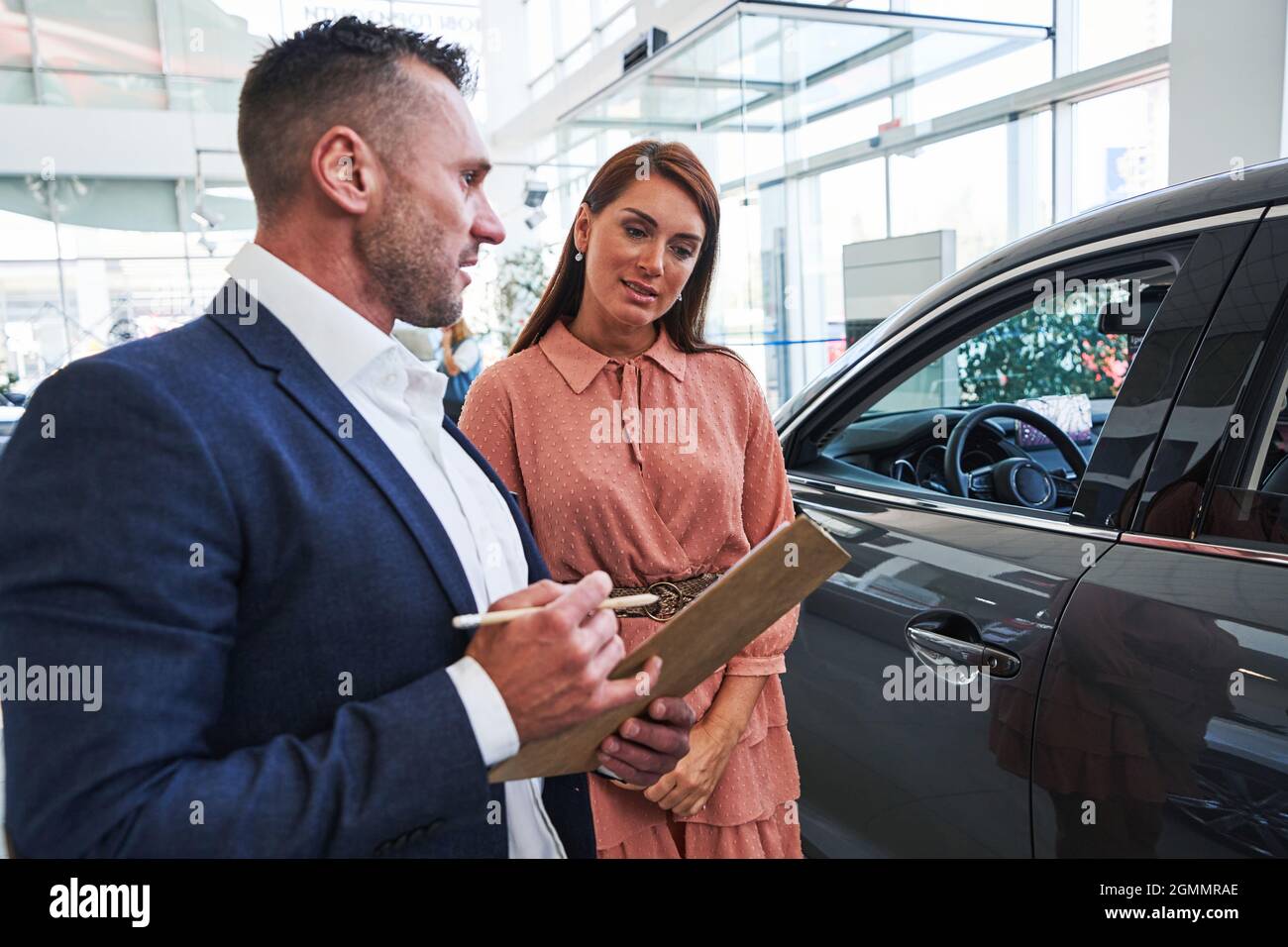 Curious customer asking questions about the contract in dealership ...