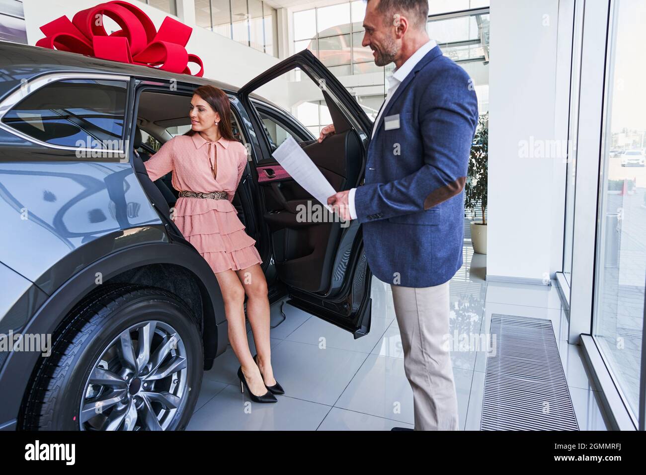 Attentive customer taking close look at the car salon Stock Photo - Alamy