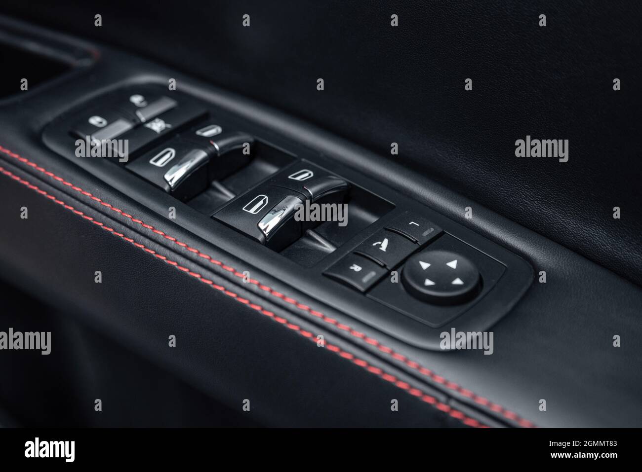 Close-up of the side door buttons: window adjustment buttons, door lock ...