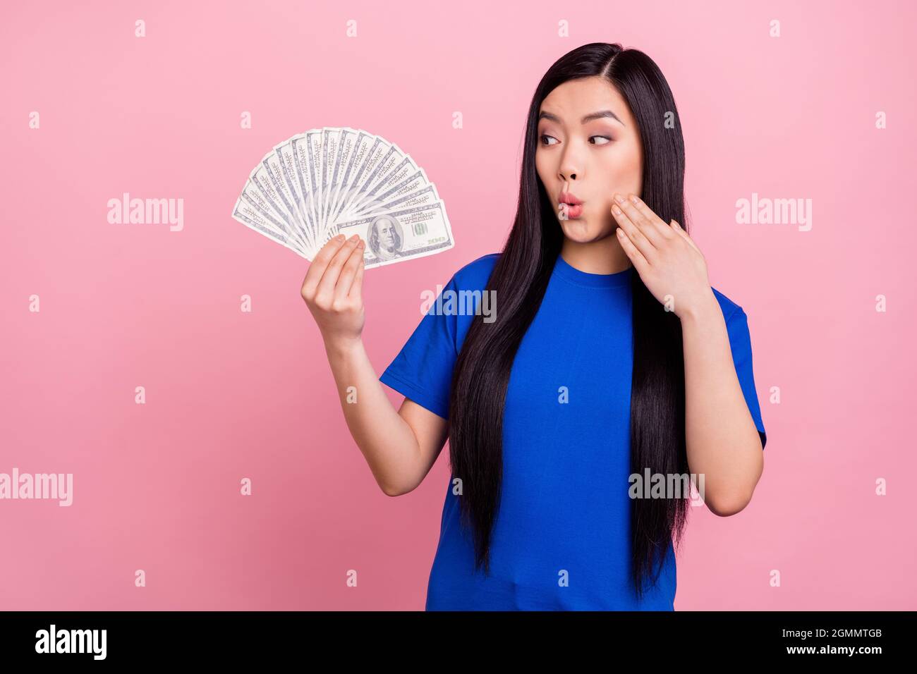 Photo of charming young woman look hold cash money shock hand face ...