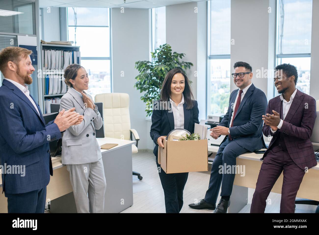 Group of successful business people in formalwear greeting new ...