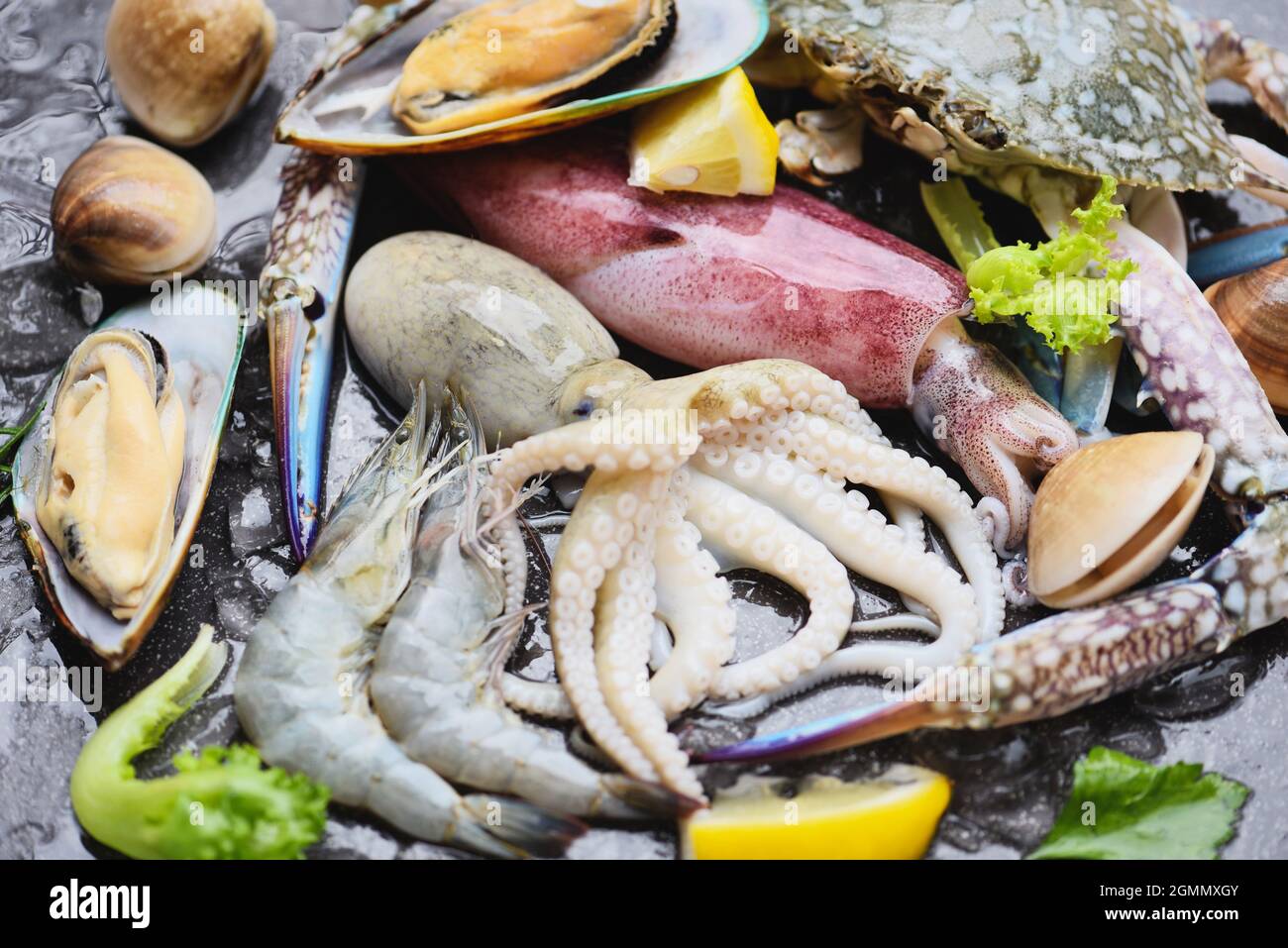 Seafood shellfish on ice frozen with shrimps prawns crab claws shell ...