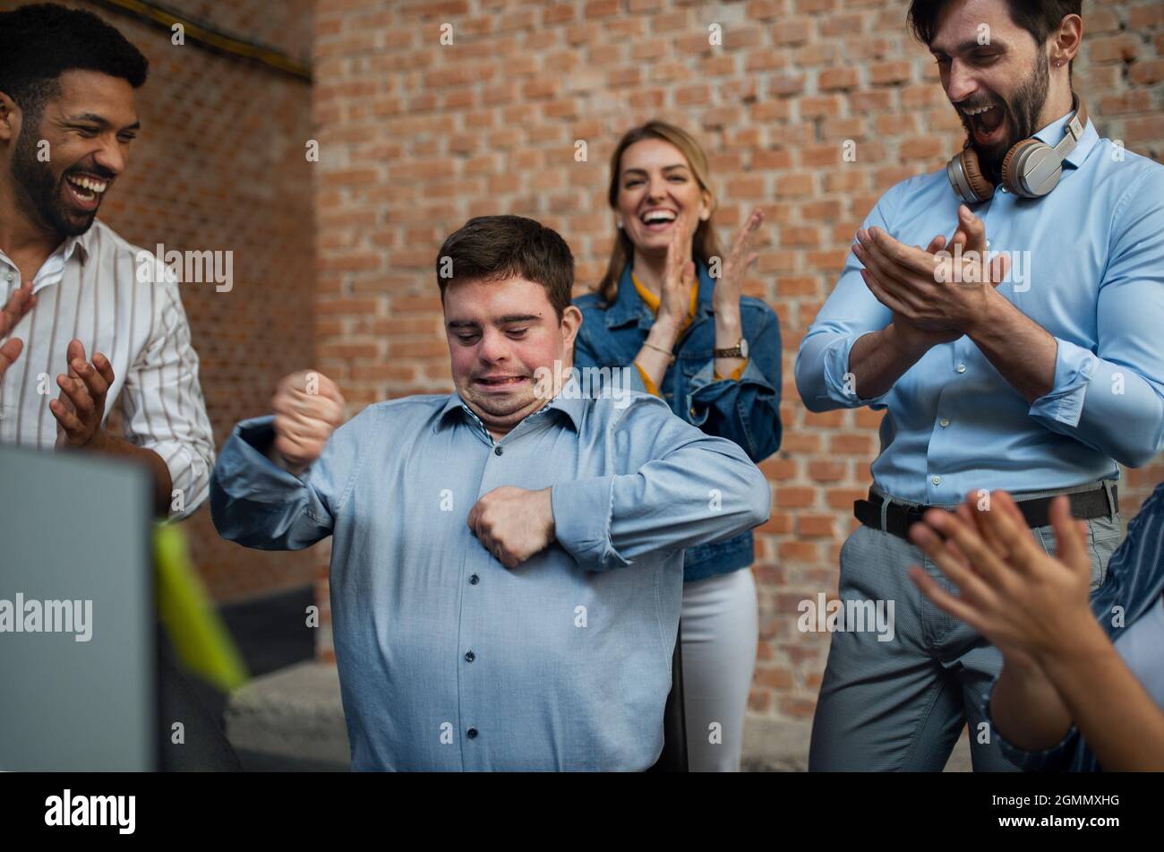 Cheerful young businesspeople having fun in office, social inclusion ...