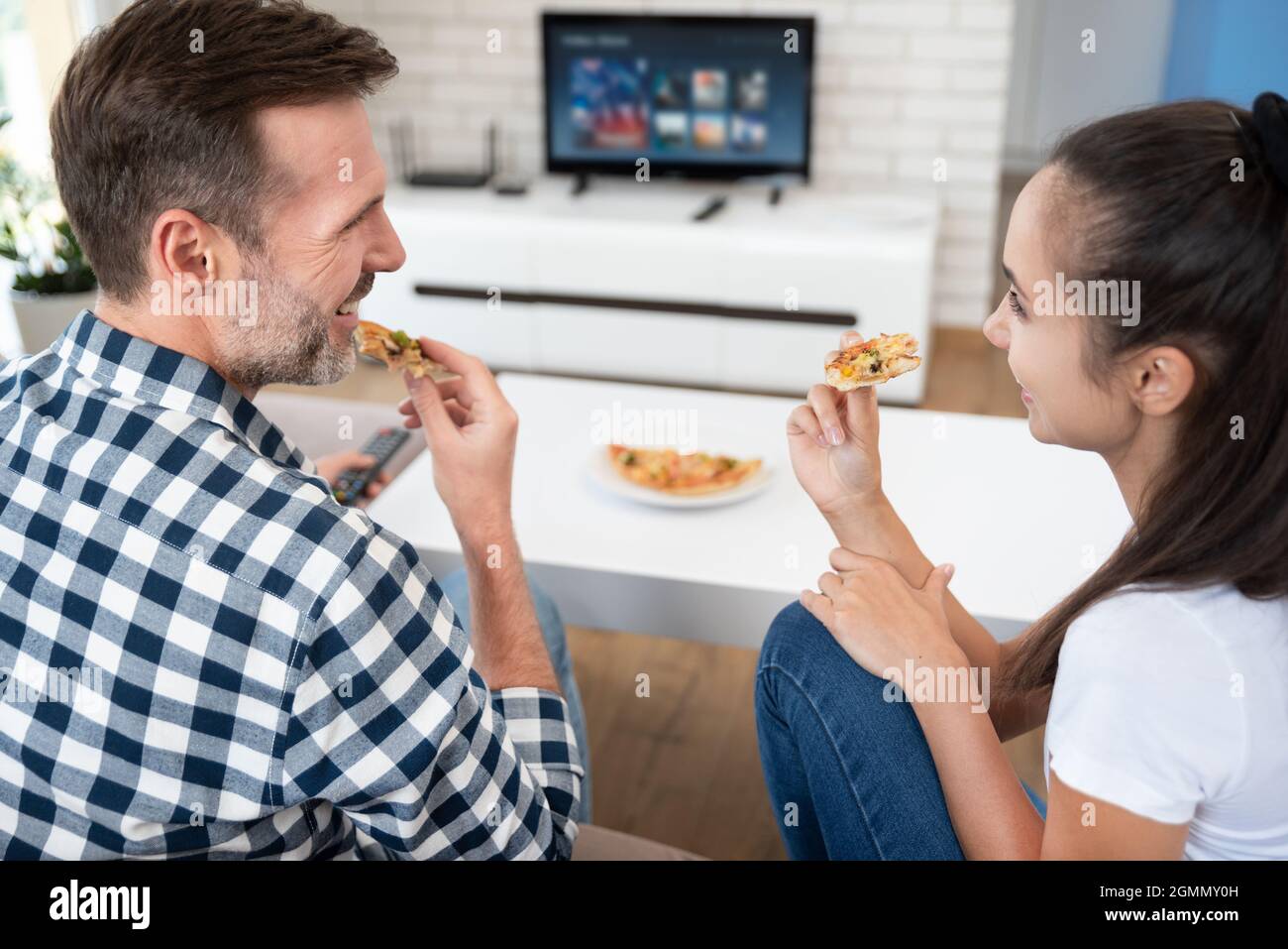 Girl eating pizza watching hi-res stock photography and images - Alamy