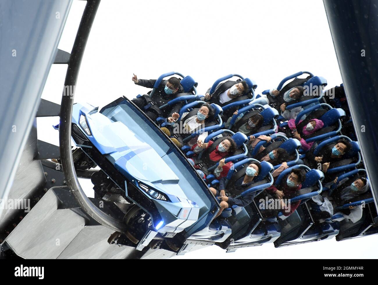 Beijing, China. 20th Sep, 2021. Tourists experience a roller coaster at ...