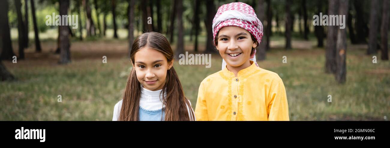 Smiling muslim kids looking at camera in park, banner Stock Photo - Alamy